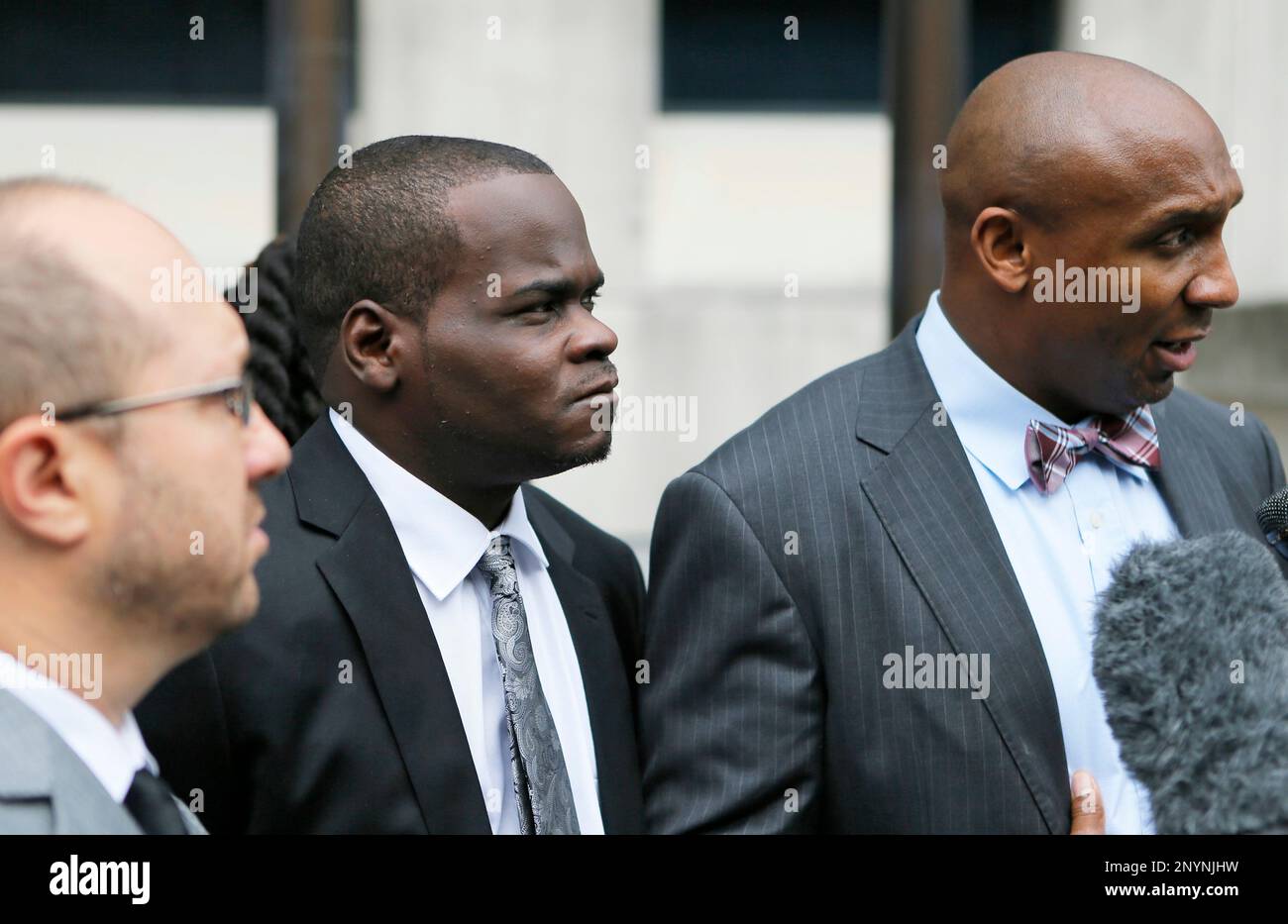 Basil Eleby stands with his attorneys during a brief press conference ...