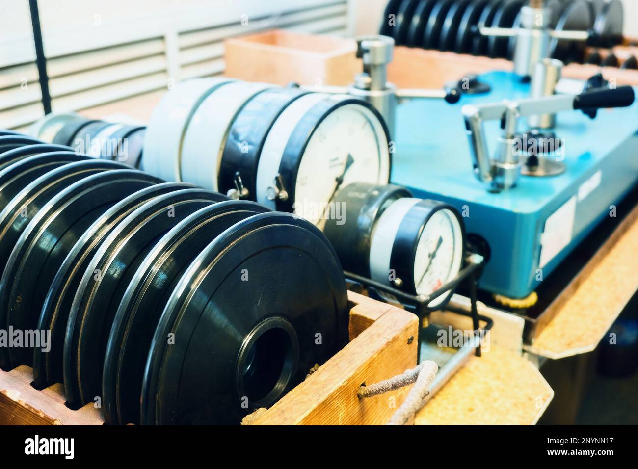 Pressure gauges and washers for calibration of instruments lie on ...