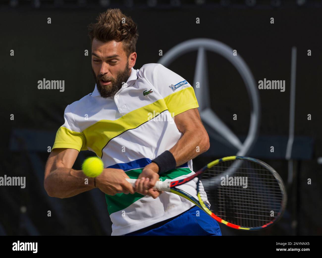 Benoit Paire of France returns the ball tio Peter Gojowczyk of Germany ...