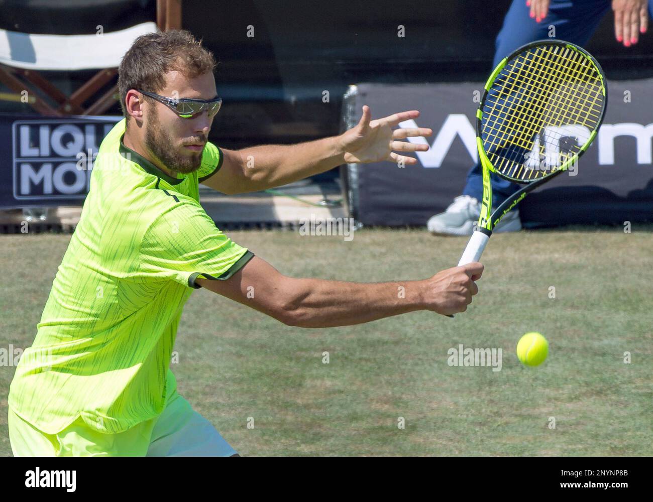 Jerzey Janowicz of Poland returns the ball to Grigor Dimitrov of ...