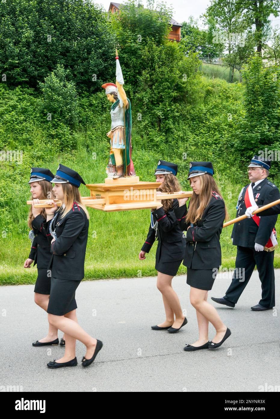 Young women in firefighters uniforms carrying Saint Florian figure ...