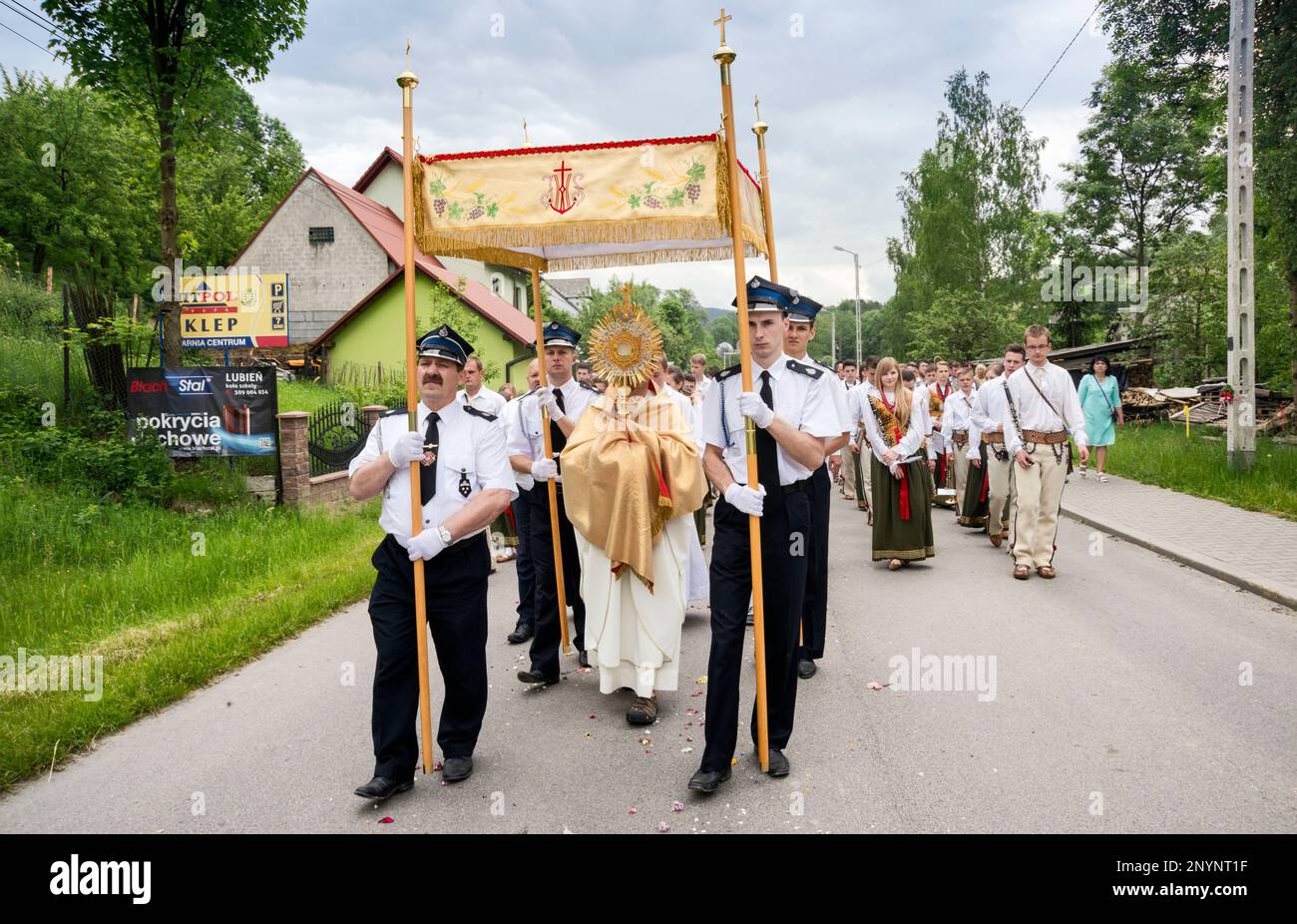 Village priest holding a monstrance, firefighters carrying a baldachin ...
