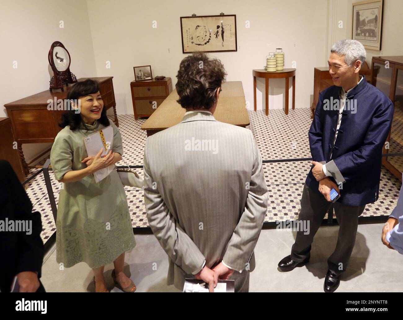 Mr Lee Hsien Yang and his wife Lee Suet Fern showing a visitor ...