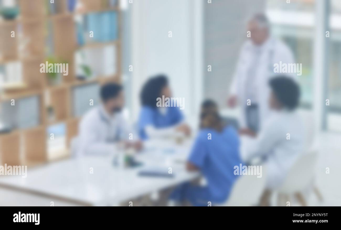 Blurred view, doctors or nurses in hospital meeting, training or ...