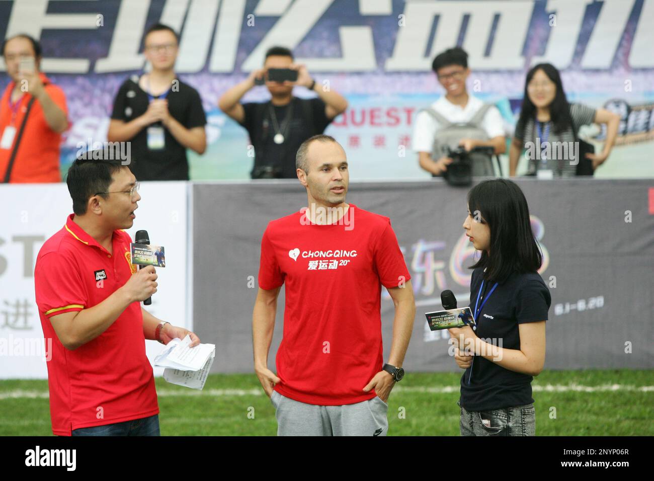Spanish football player Andres Iniesta, center, attends a commercial ...