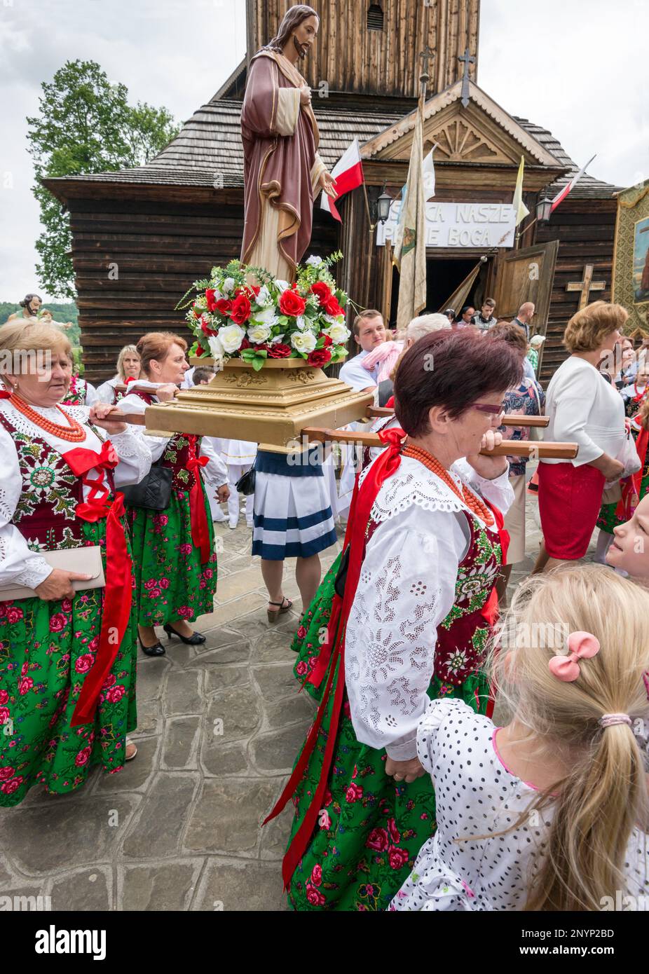 Women in traditional folk clothes, carrying Jesus Christ figure, in ...