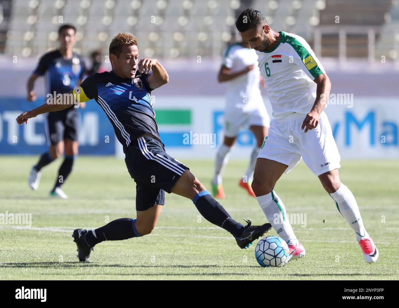 Japan's Keisuke Honda (L) competes a ball in the first half of the FIFA ...