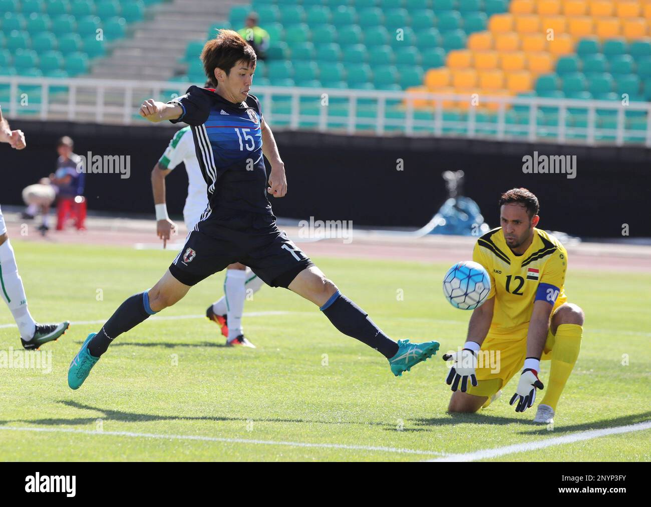 Japan's forward Yuya Osako (L,15) toes a ball in the first half of the ...