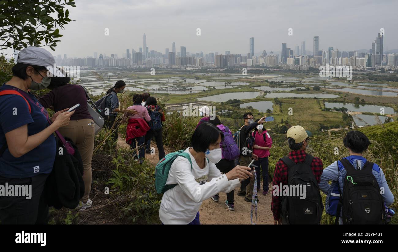 People hiking in Ma Tso Lung at Lok Ma Chau. The background is the view ...