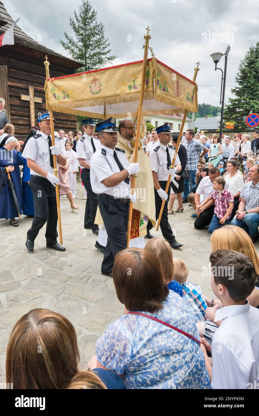 Village priest holding a monstrance, firefighters carrying a baldachin ...