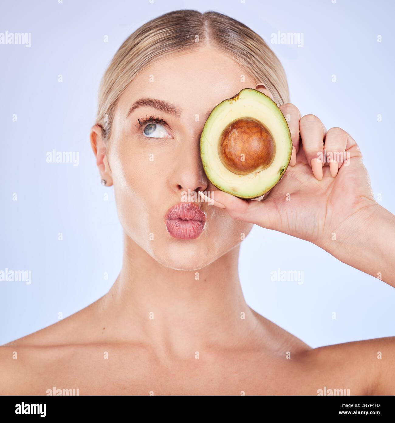 Skincare, face and woman with avocado in studio isolated on a blue ...