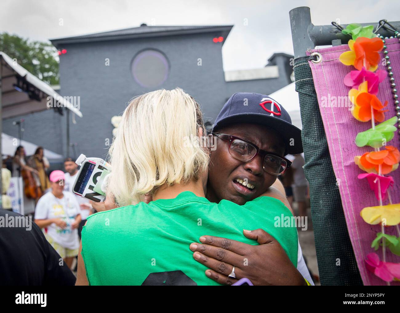 Estella Peterkin, right, hugs Chris Callen during a community gathering ...