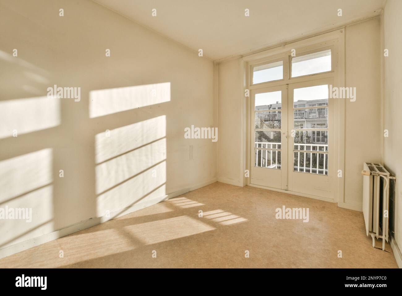 an empty room with the sun shining on the floor and window panes in the ...