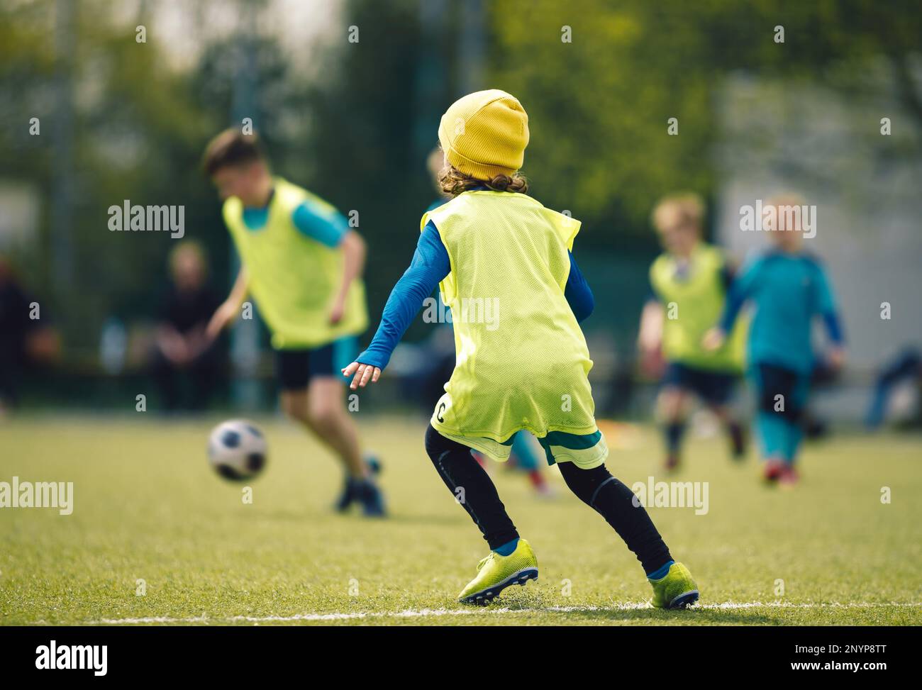 Children play football during winter soccer tournament. Kids play ...