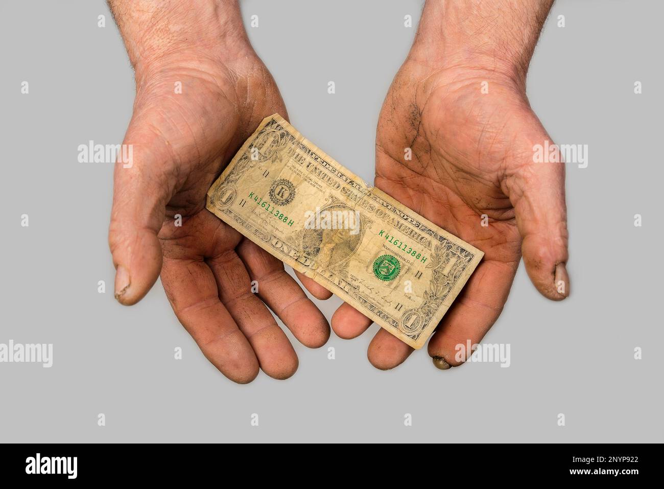 One dollar in overworked male hands. Real poverty concept Stock Photo ...