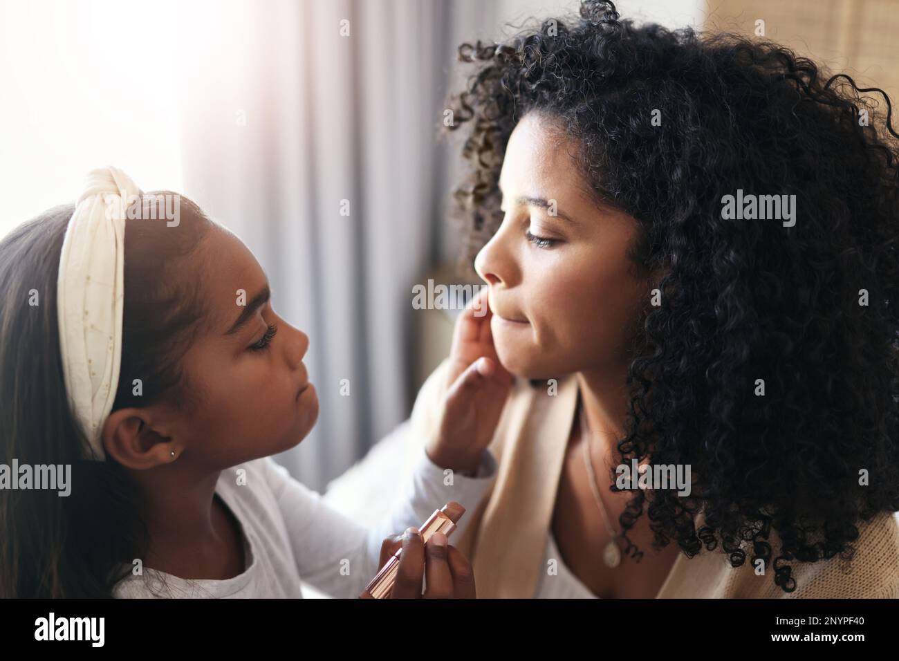 Makeup, bonding and child with mother for lipstick, applying cosmetics ...