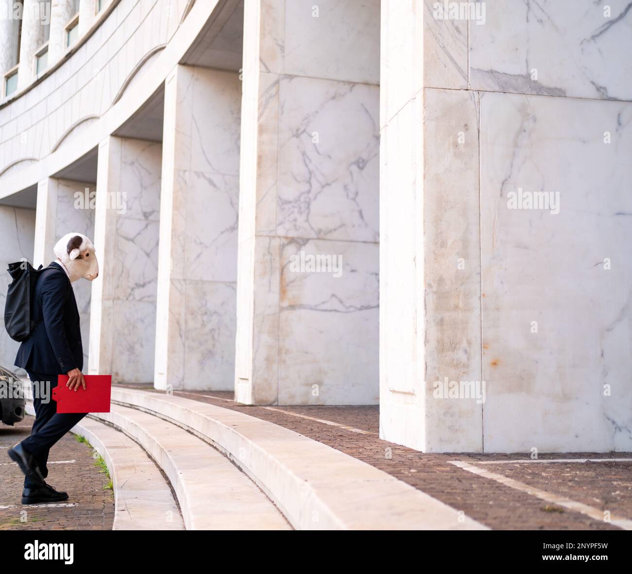 Sad businessman with sheep head walking to work with a red document ...