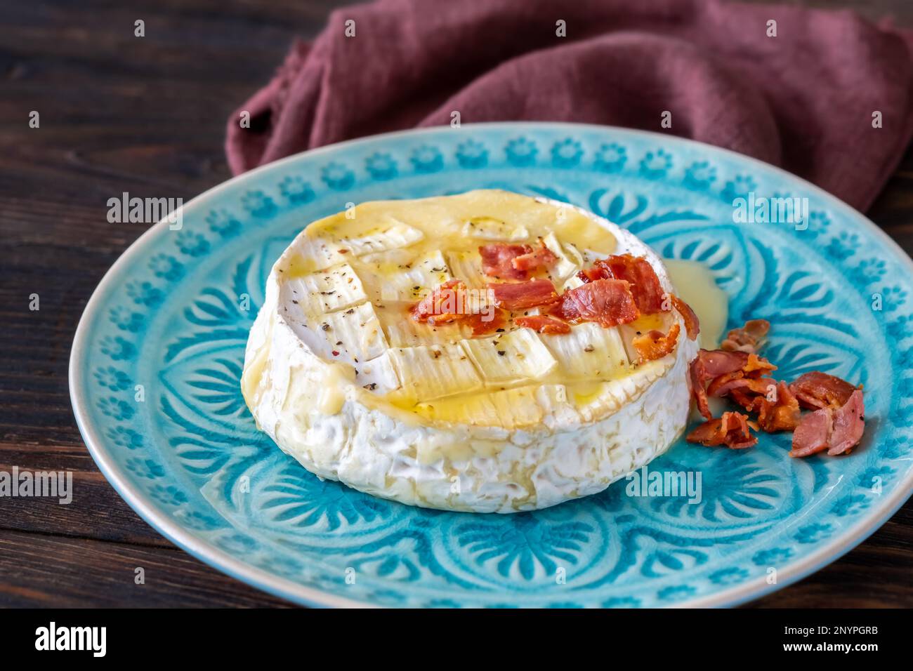 Baked Camembert cheese with crumbled fried bacon Stock Photo - Alamy