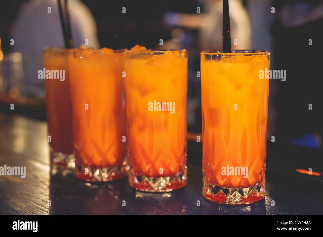 View of alcohol on a party, row line of orange red colored aperitif ...