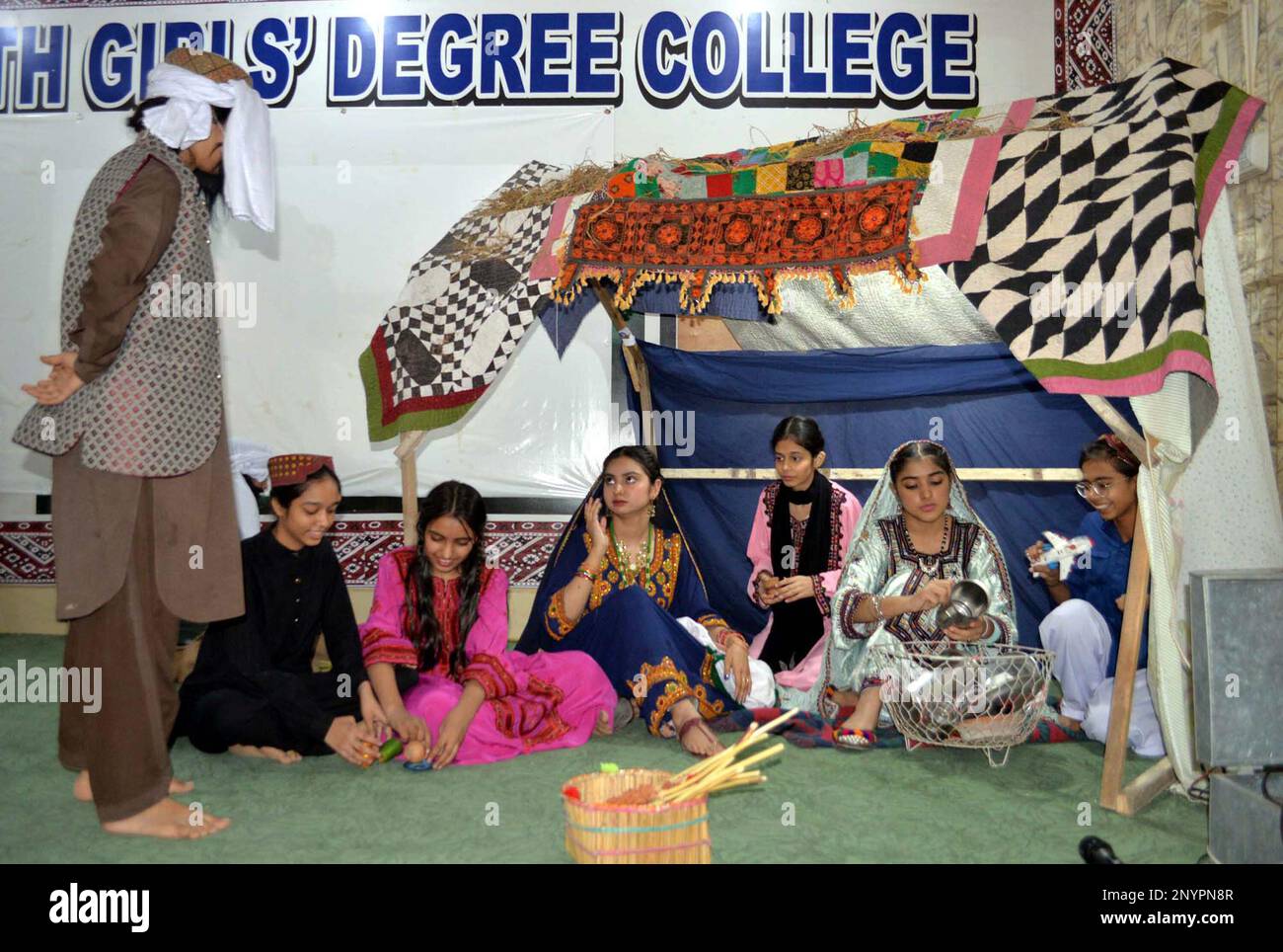 Students are performing tableau on stage during a ceremony held at ...