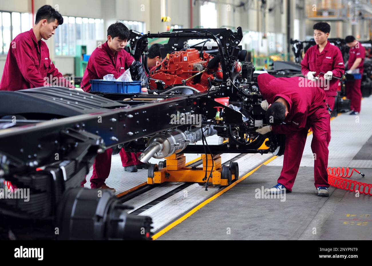 In this April 17, 2017, photo, workers assemble a truck chassis at an ...