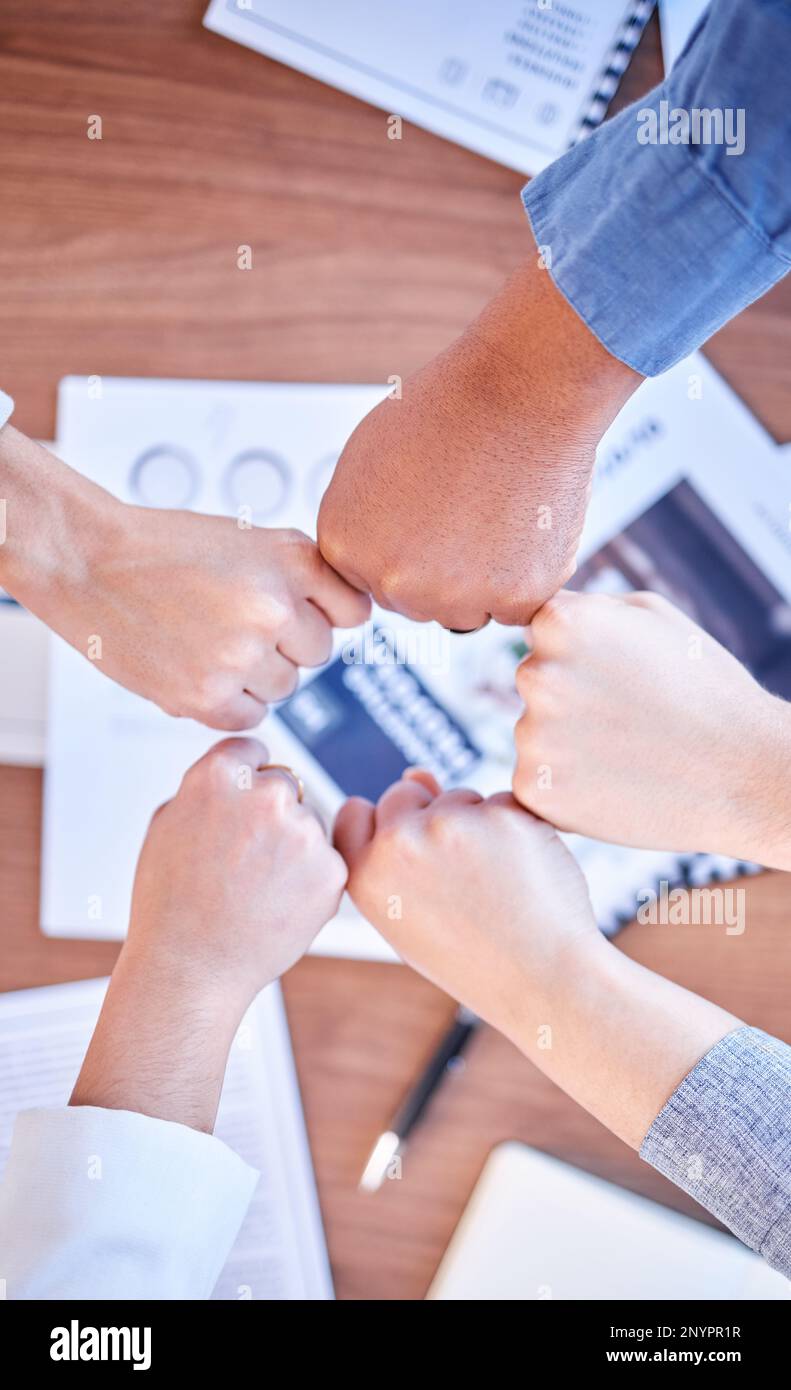 Fist bump, solidarity and above of business people hands for motivation, partnership and support ...
