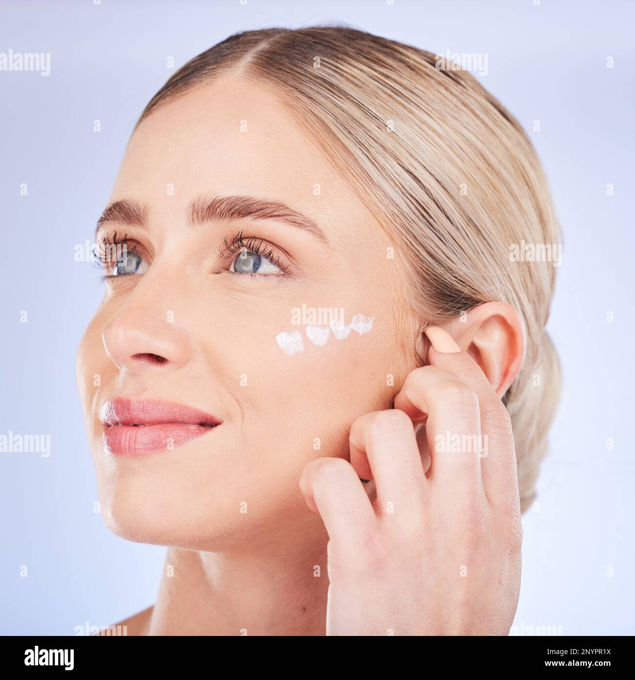 Beauty, face skincare and woman with cream in studio isolated on a blue ...