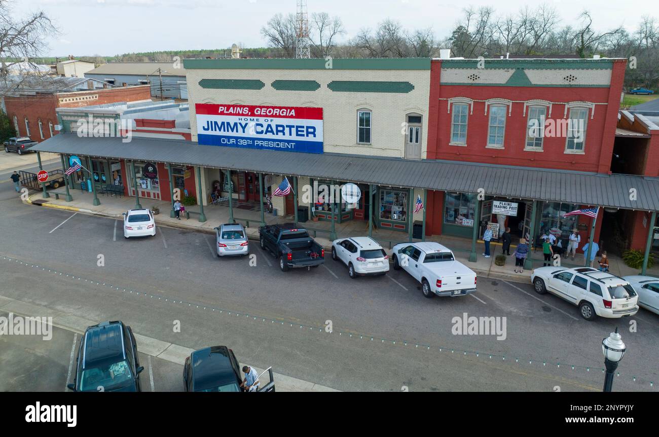 Visitors walk along the storefronts on Main Street in Plains, Ga., the ...