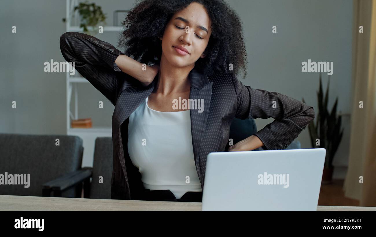 Tired exhausted african woman businesswoman employee sit at office desk ...