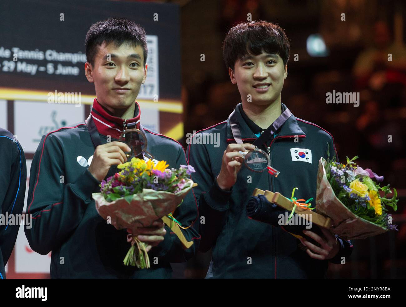 Sangsu Lee, left, and Youngsik Jeoung from Korea, pose for a photo at the victory ceremony for ...