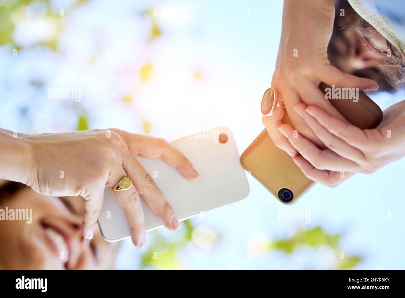 Hands, bottom view or girl friends with phone in park with smile for ...