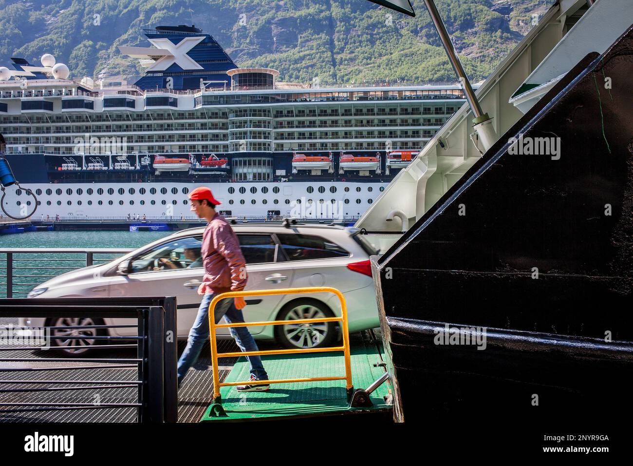 Person and car going out the ferry, in harbour of Geiranger ...