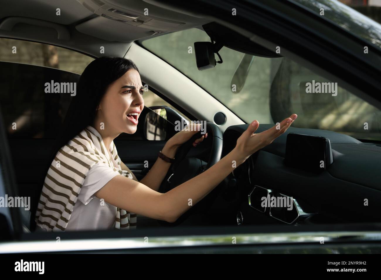 Stressed young woman driver's seat of modern car Stock Photo - Alamy