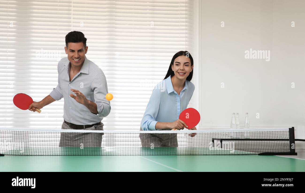 Business people playing ping pong in office Stock Photo - Alamy
