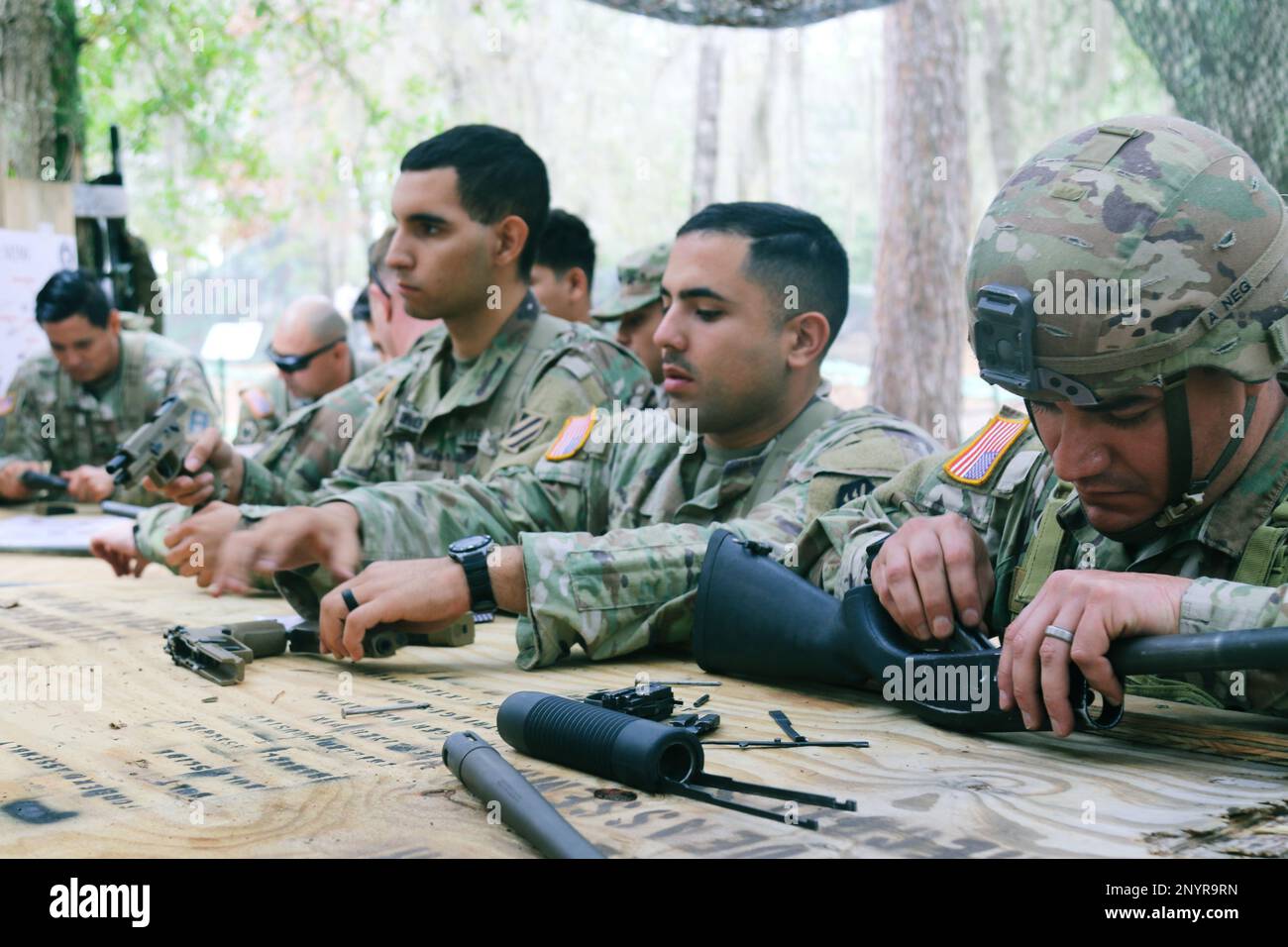 Soldiers from the 3rd Infantry Division dissemble and reassemble the ...