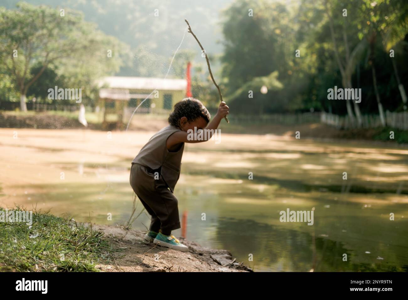 A Child is fishing in a Pond, Guwahati,Assam Stock Photo - Alamy