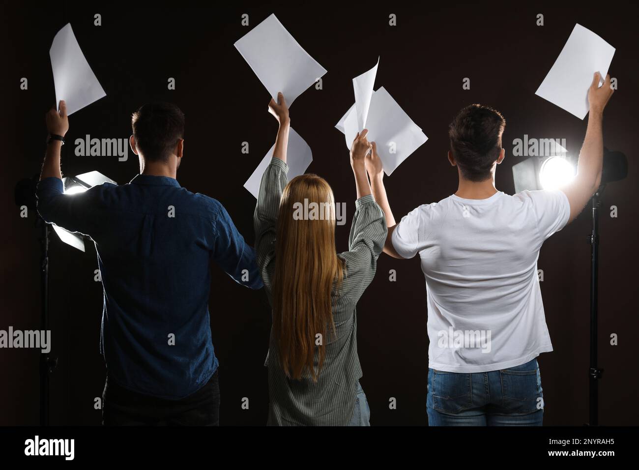 Professional actors bowing on stage in theatre, back view Stock Photo ...