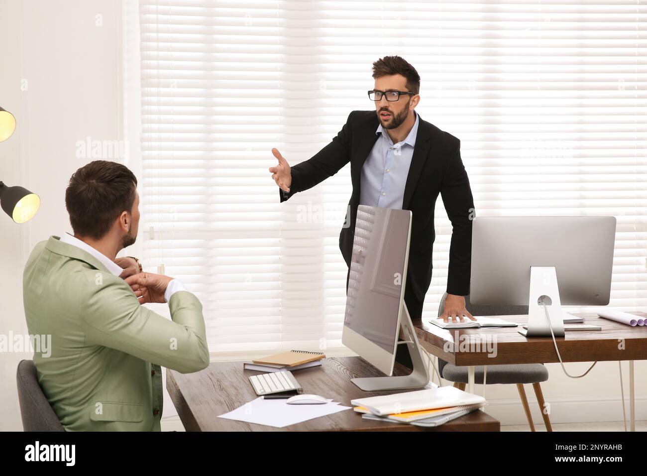 Emotional colleagues arguing in office. Toxic work environment Stock ...