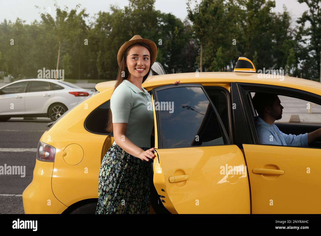 Woman getting into taxi hi-res stock photography and images - Alamy