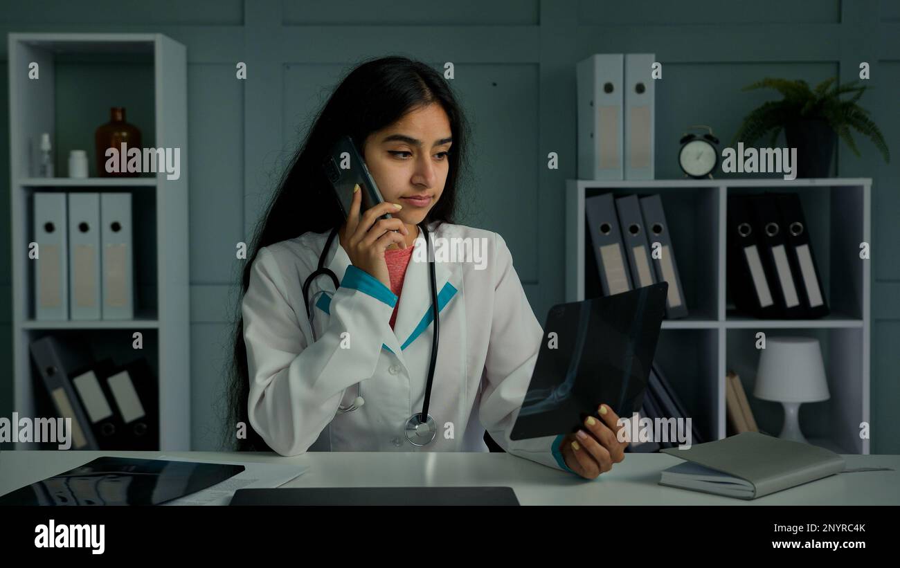 Doctor radiologist young woman surgeon explore x-ray scan MRI result ...