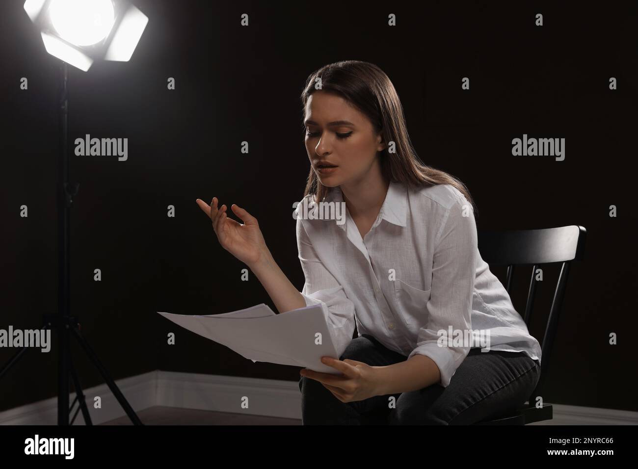 Professional actress reading her script during rehearsal in theatre ...