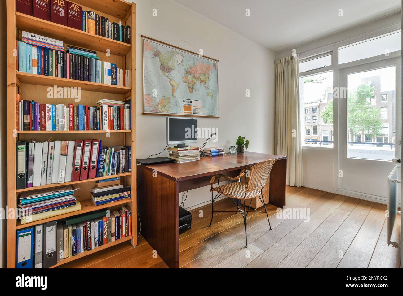 a home office with books on the shelves and a computer sitting on a ...