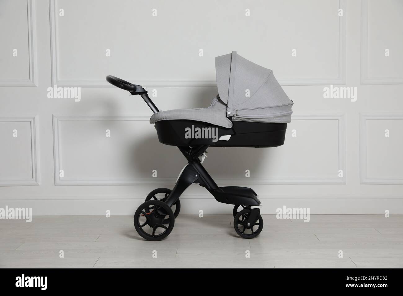 Baby carriage. Modern pram near white wall Stock Photo - Alamy