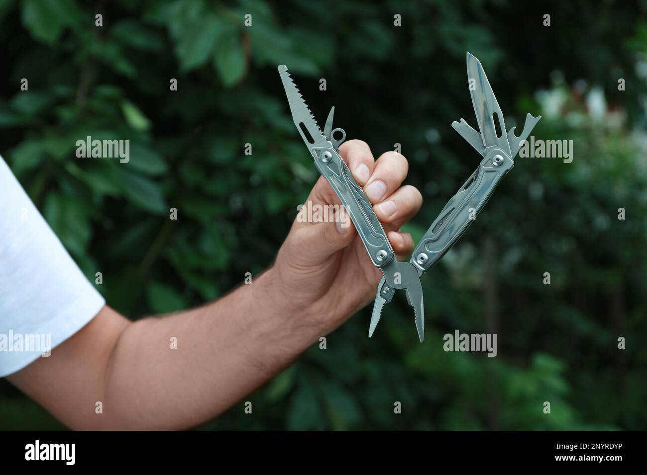 Man holding compact portable multitool outdoors, closeup Stock Photo ...