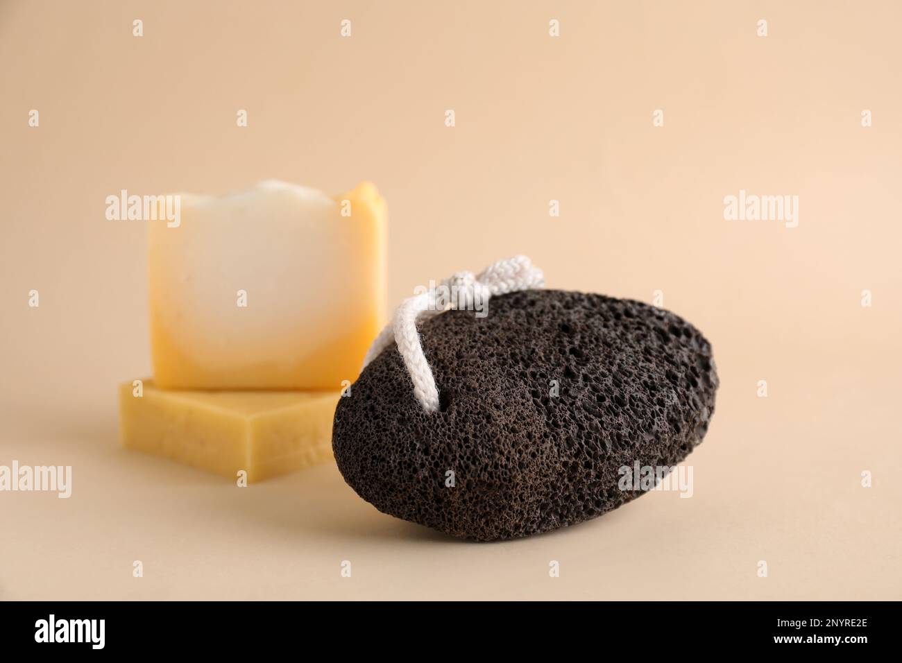 Pumice stone and soap bars on beige background Stock Photo - Alamy