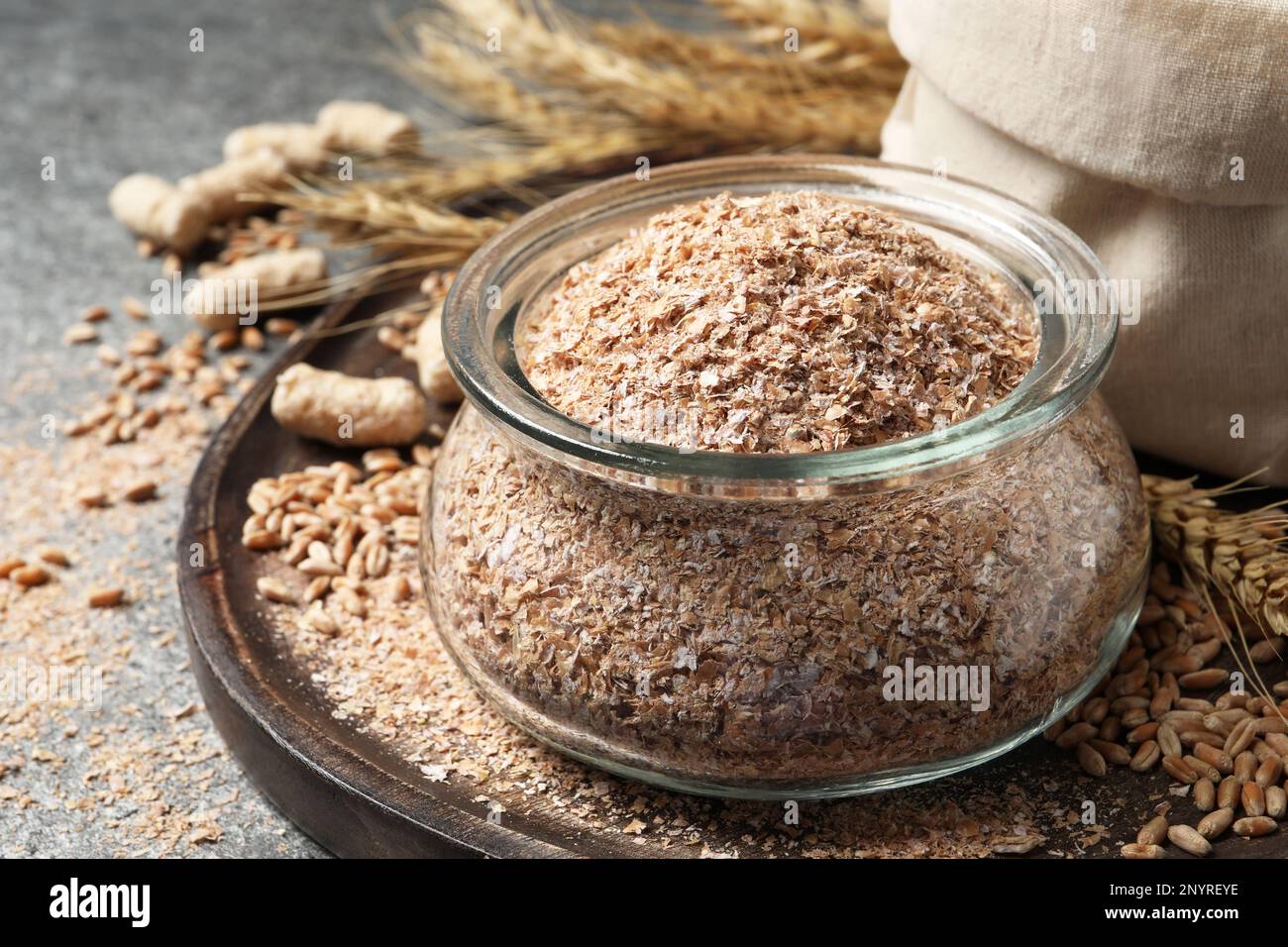 Jar of wheat bran on grey table Stock Photo - Alamy