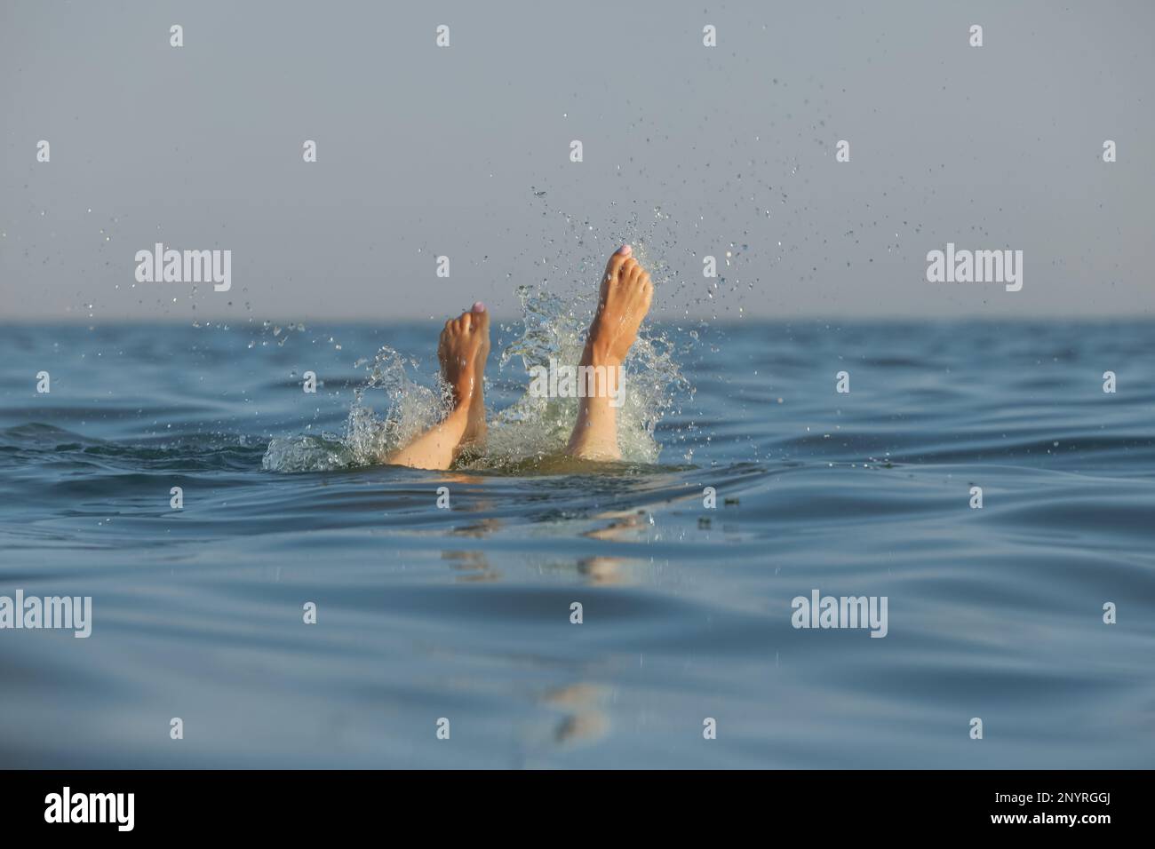 Drowning woman's legs sticking out of sea Stock Photo - Alamy