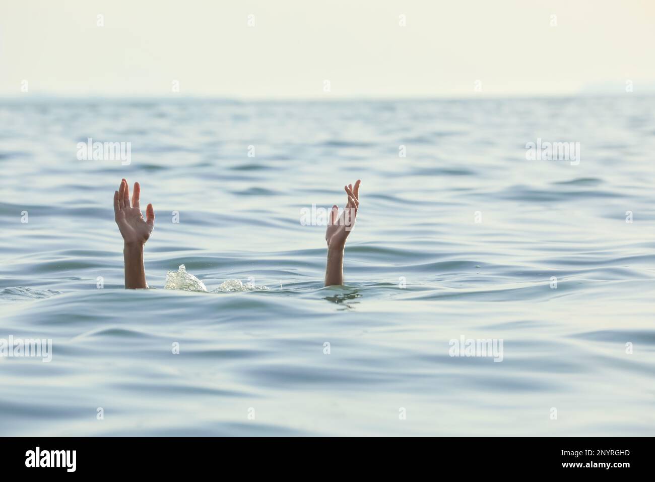 Drowning woman reaching for help in sea Stock Photo - Alamy