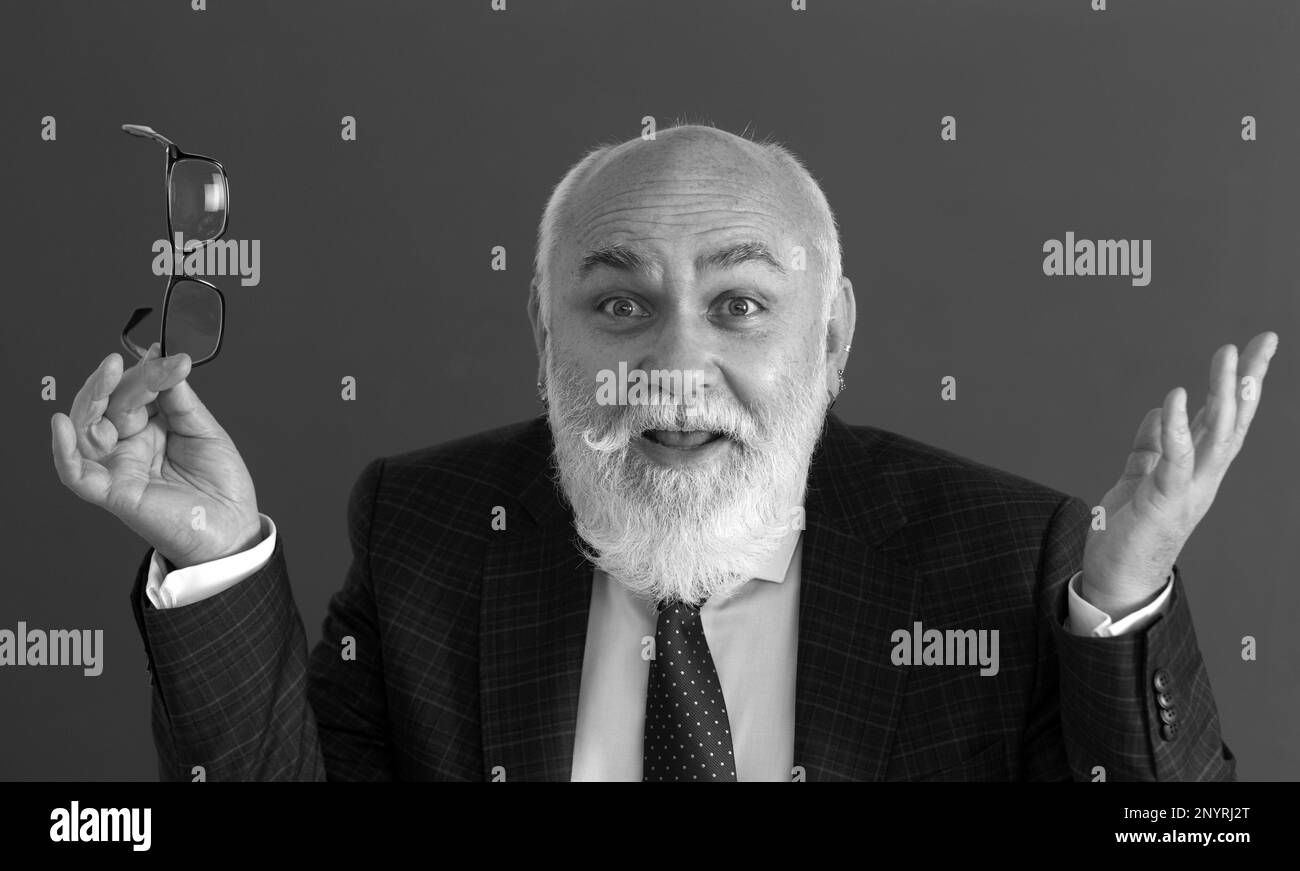 Senior academic professor on lecture near empty blackboard. Knowledge ...