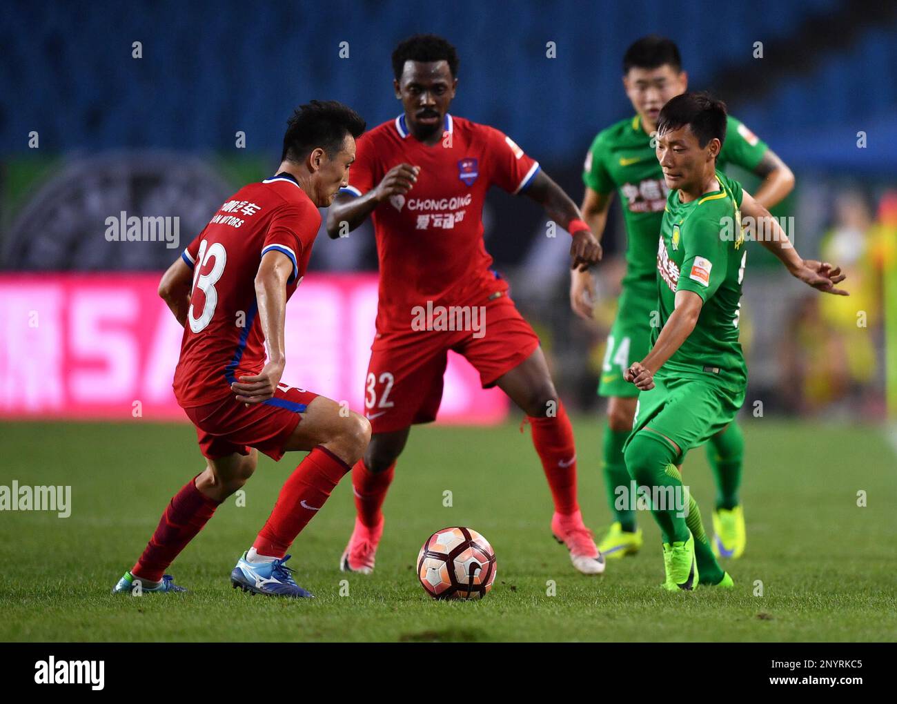 Brazilian football player Fernandinho, center, of Chongqing Lifan kicks ...